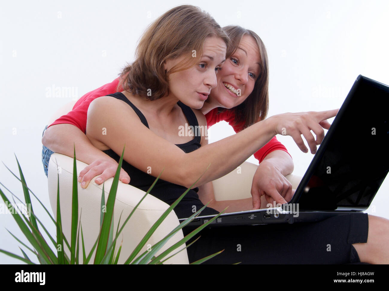 Two young women using laptop Stock Photo - Alamy