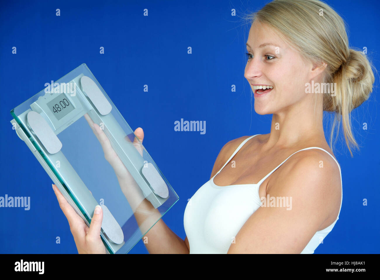 Woman with scale Stock Photo - Alamy
