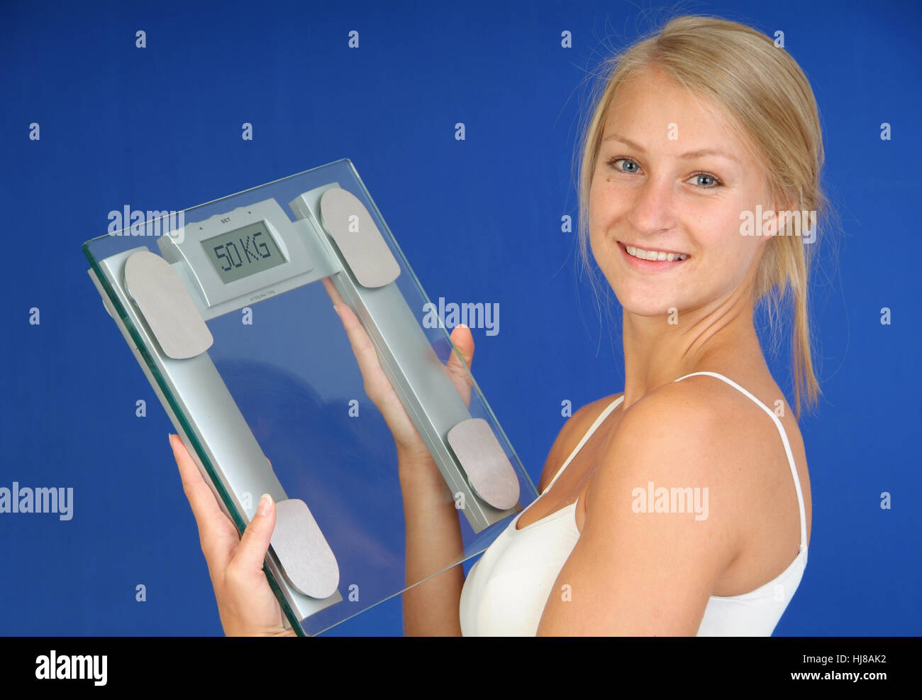 Woman with scale Stock Photo - Alamy