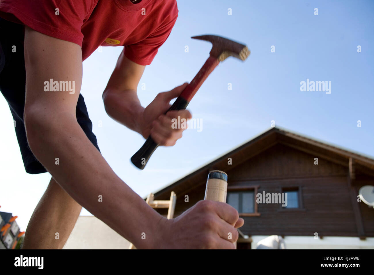 Young man works hammer and chisel Stock Photo - Alamy