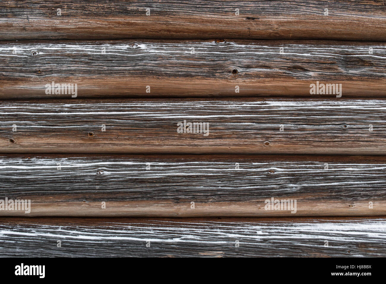 log wall covered snow background Stock Photo - Alamy