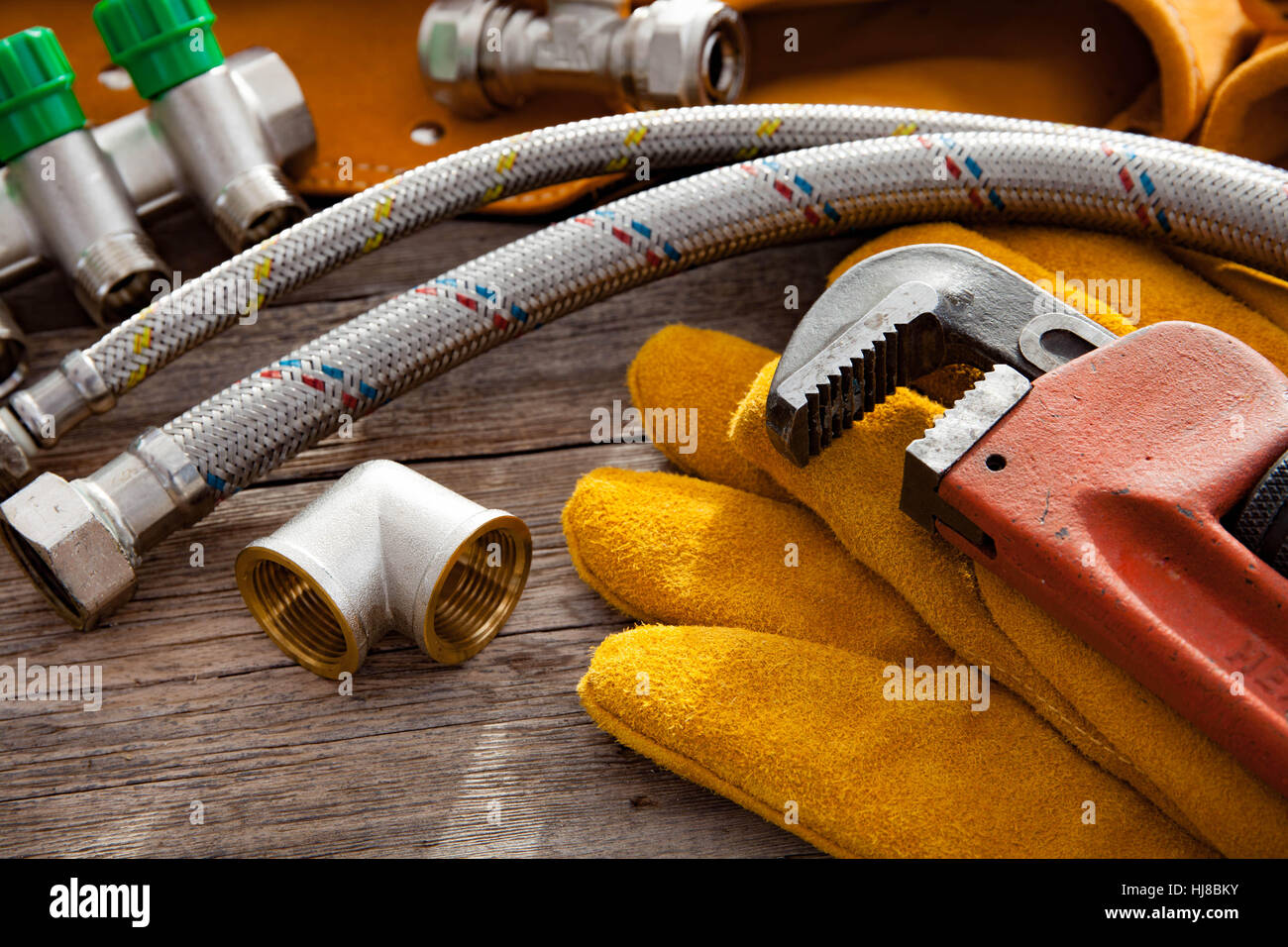 Set of plumbing and tools on the wooden table Stock Photo - Alamy