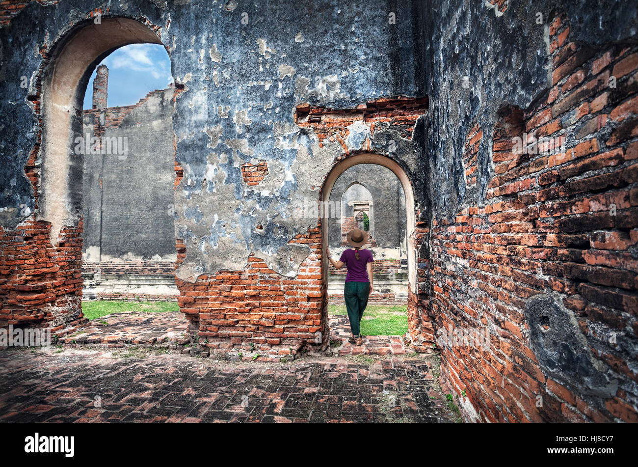 Woman in hat looking at ancient ruined in Lopburi, Thailand Stock Photo ...