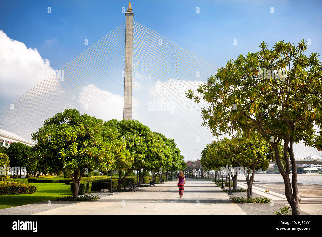Woman walking in the park near Bridge of Rama VII in Bangkok, Thailand ...