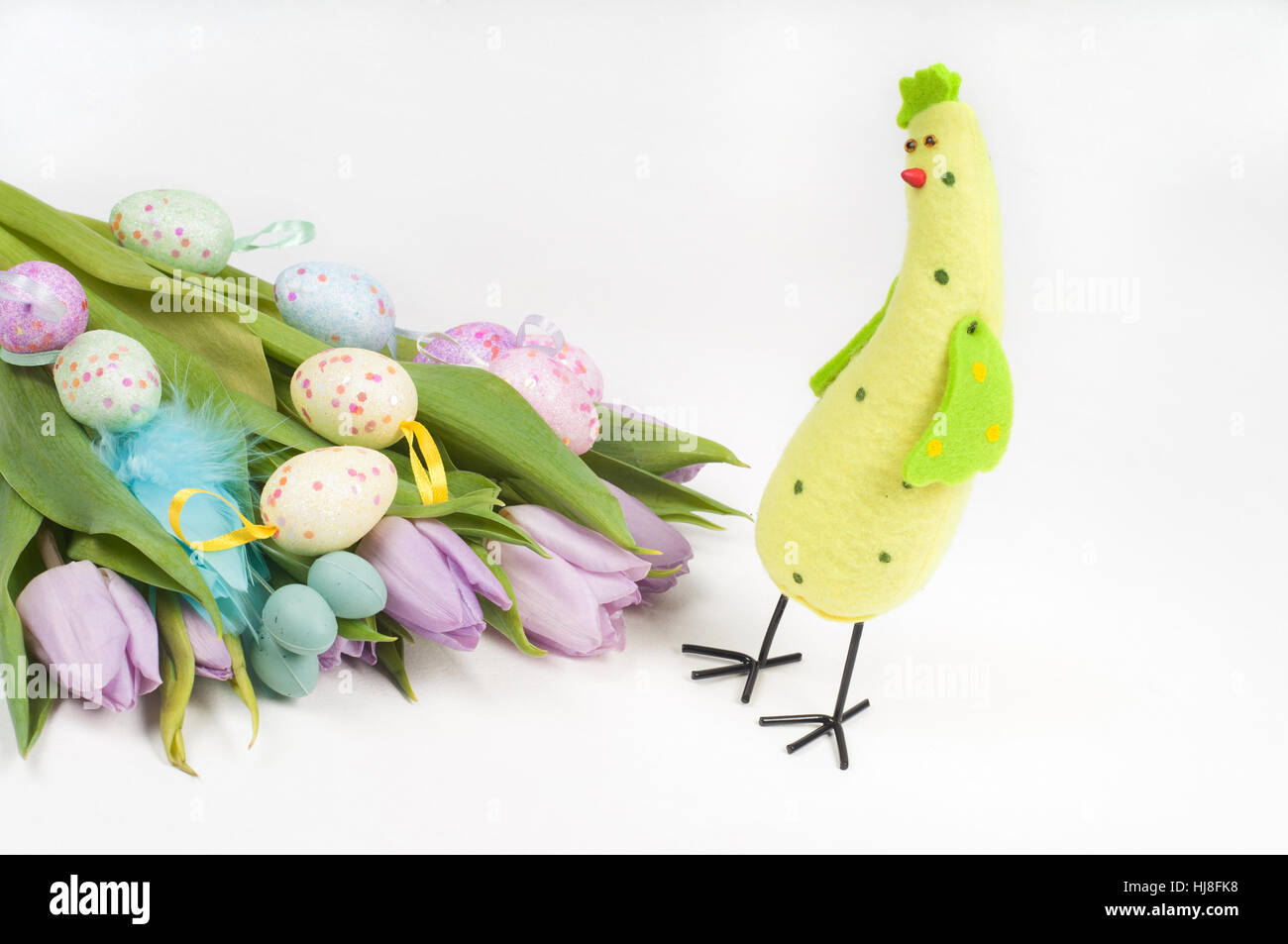 Easter chicken with eggs and tulips on light background Stock Photo - Alamy