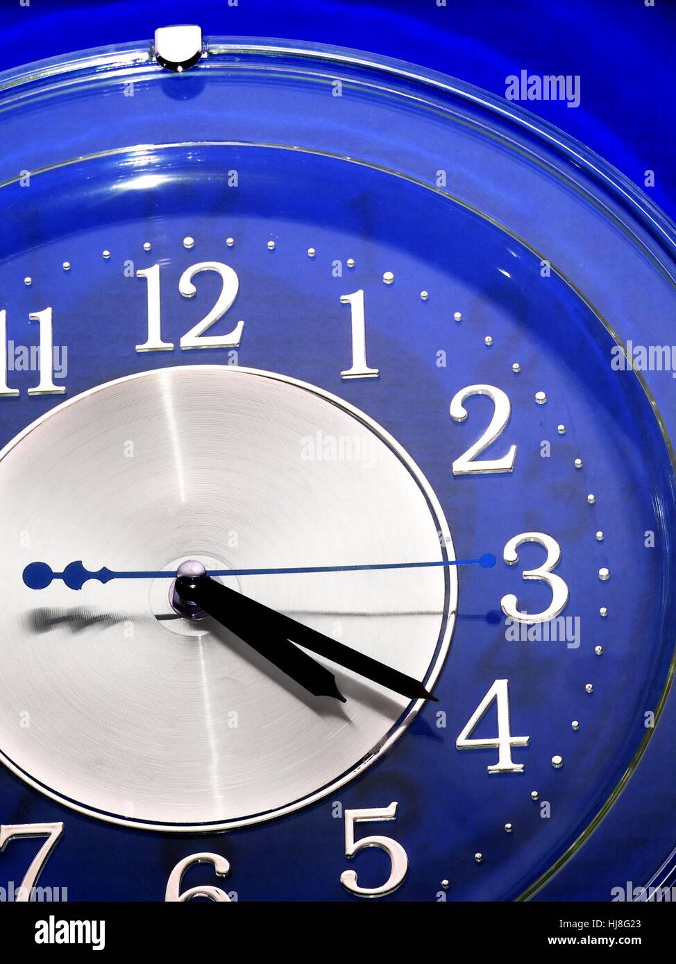 Detail of an analogue clock in blue tone Stock Photo - Alamy