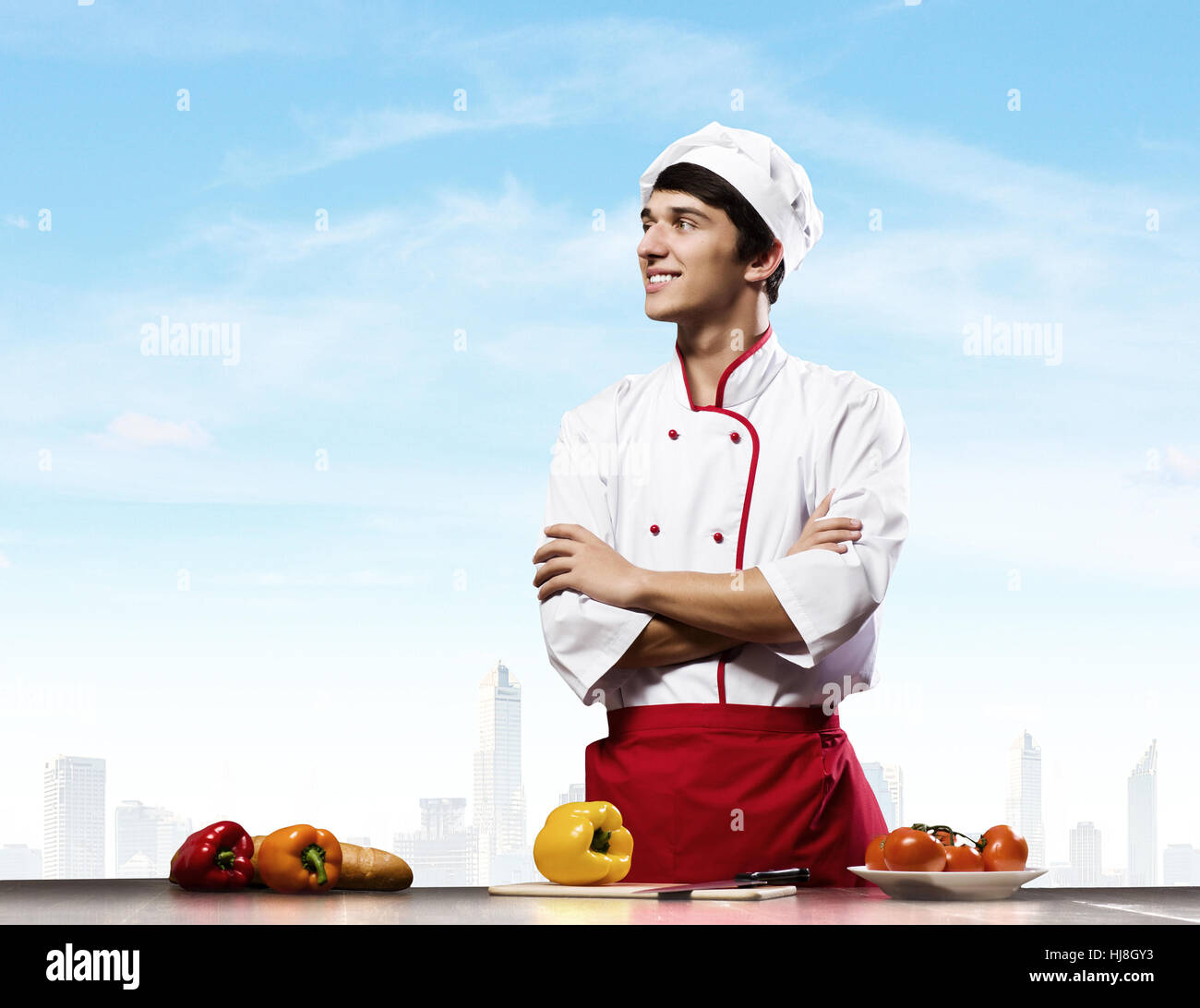 Young cheerful cook and ingredients flying in air Stock Photo - Alamy