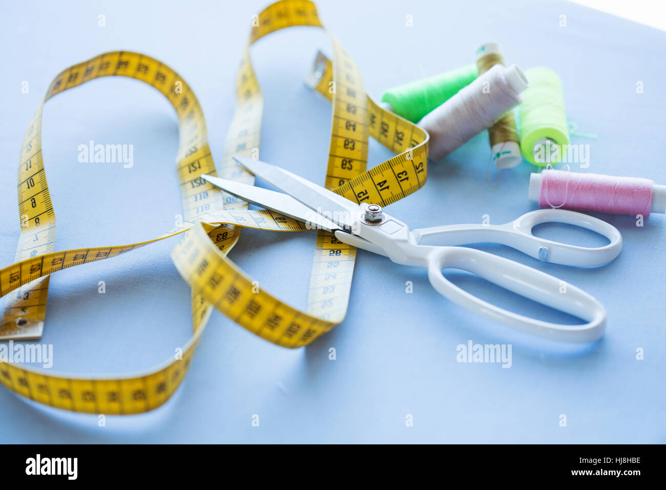 Scissors measuring tape and threads on table hi-res stock photography ...