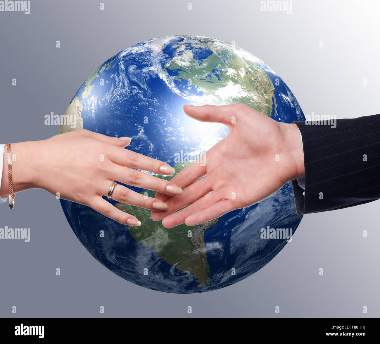 Business handshake on the background of the Earth. The symbol of a ...