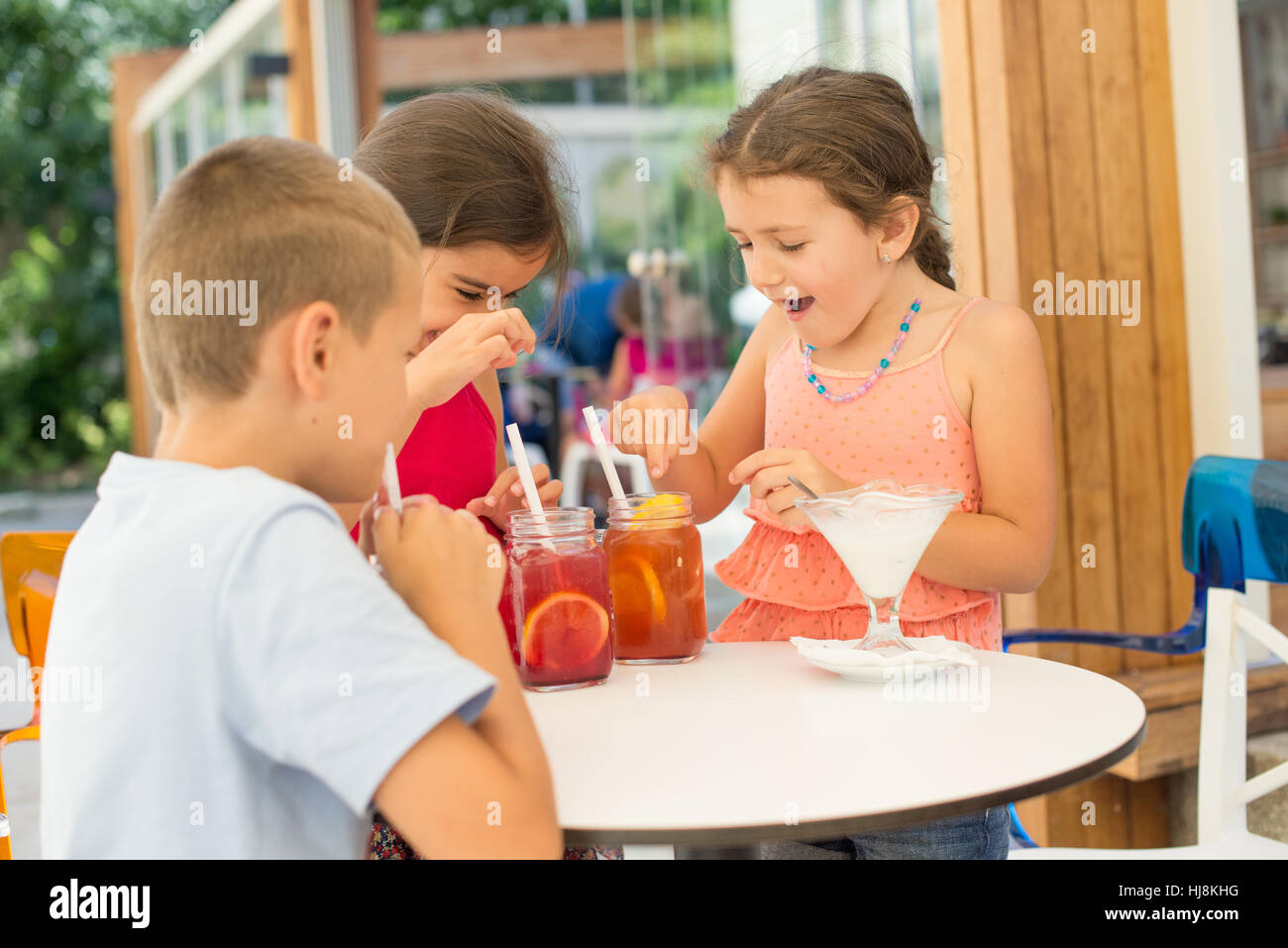 Three children with ice-tea drinks Stock Photo - Alamy