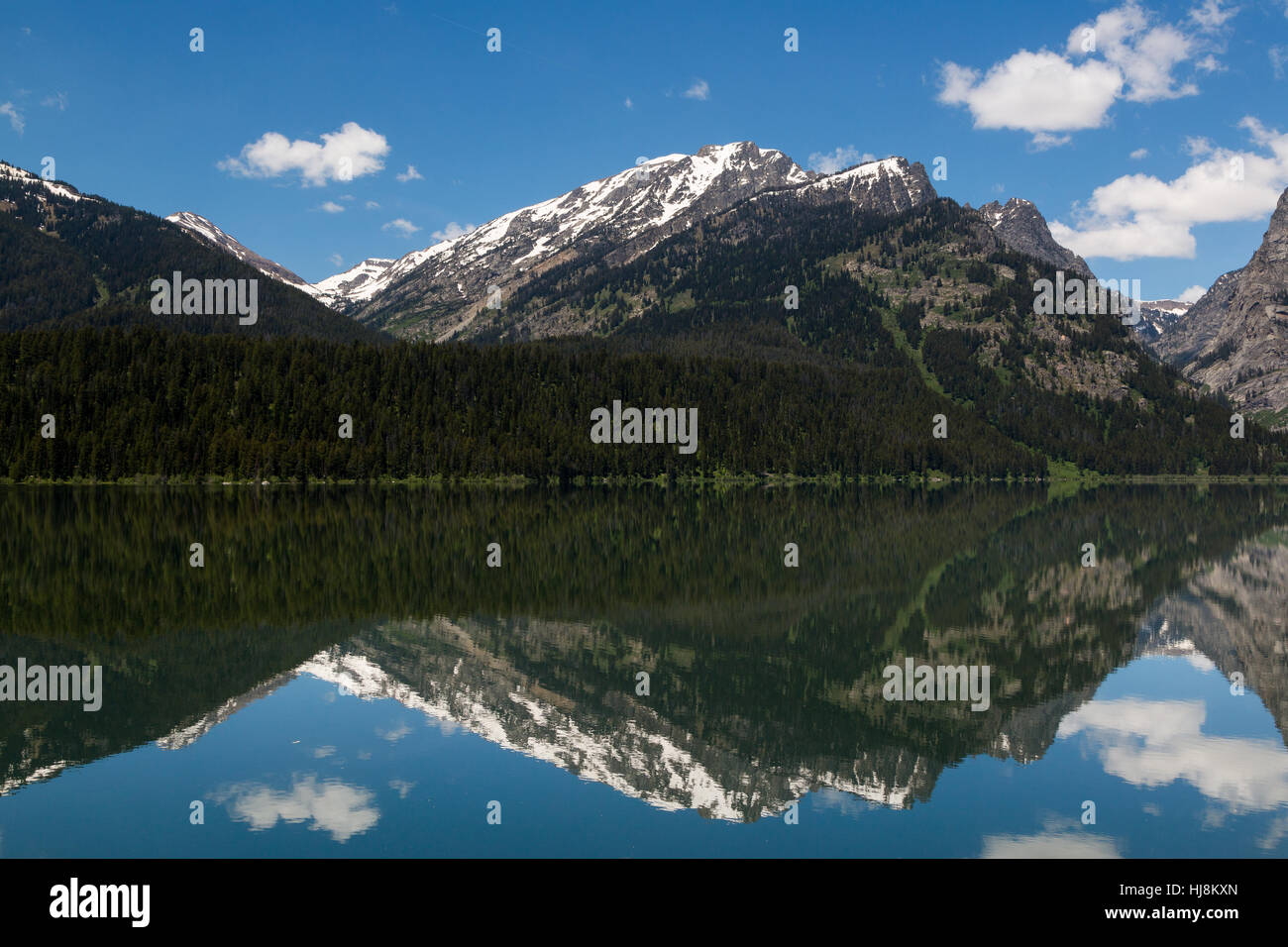 Phelps Lake casting a mirror reflection of the Teton Mountains in ...