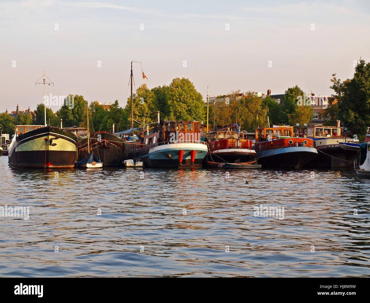 Amsterdam channels traditional view with small boats Stock Photo - Alamy
