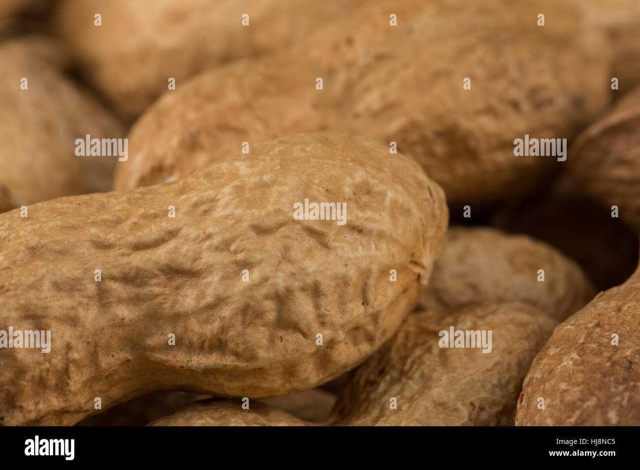 Pile of peanuts shells close up for background Stock Photo - Alamy