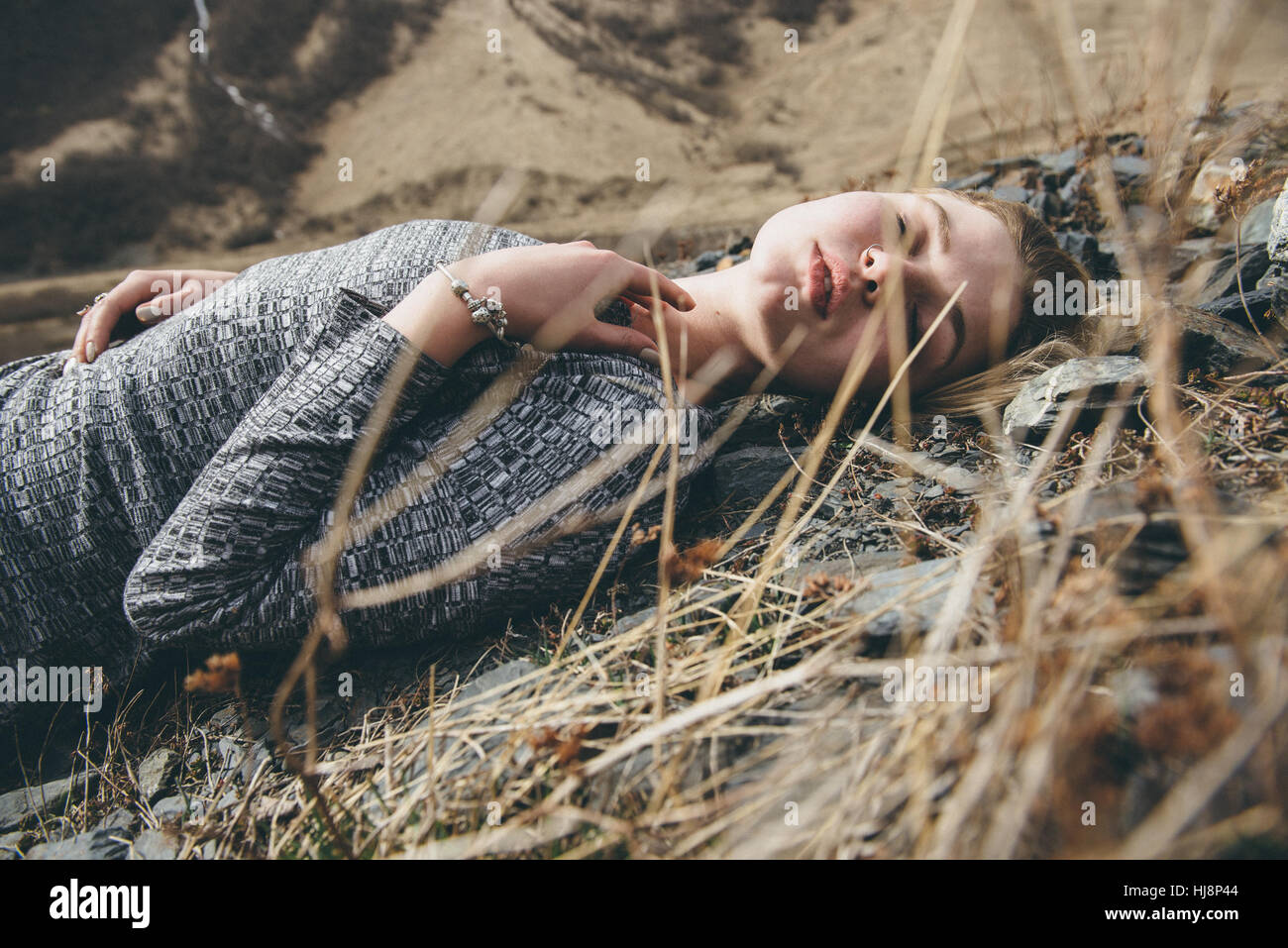 Woman sleeping on rocks hi-res stock photography and images - Alamy