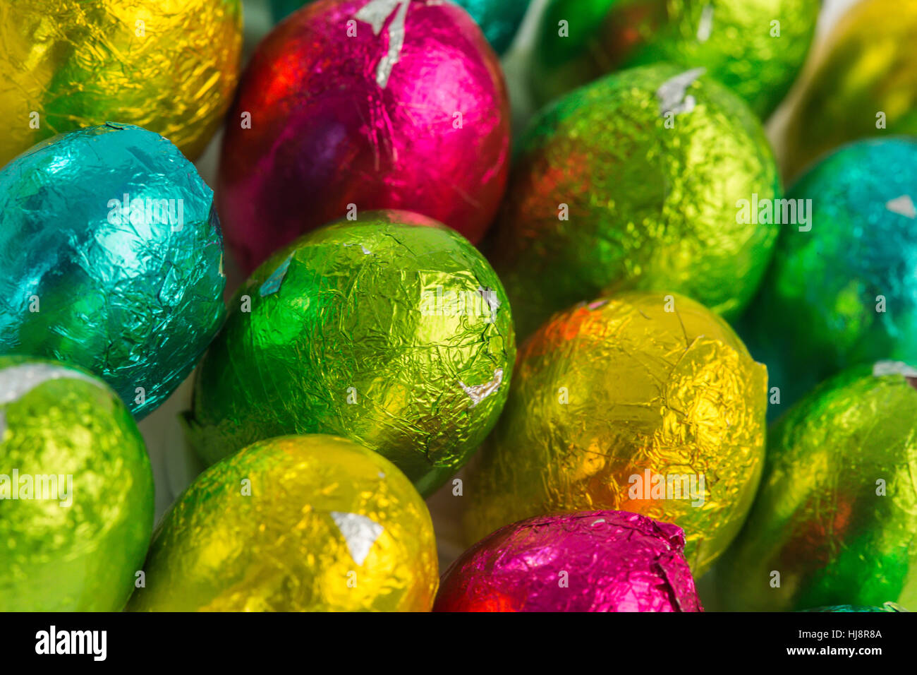 Colourful foil wrapped easter eggs overhead shot Stock Photo - Alamy
