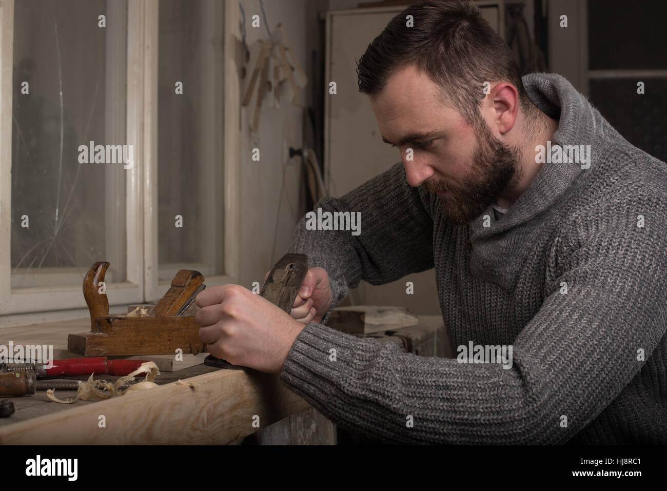 Carpenter using a hand plane Stock Photo - Alamy