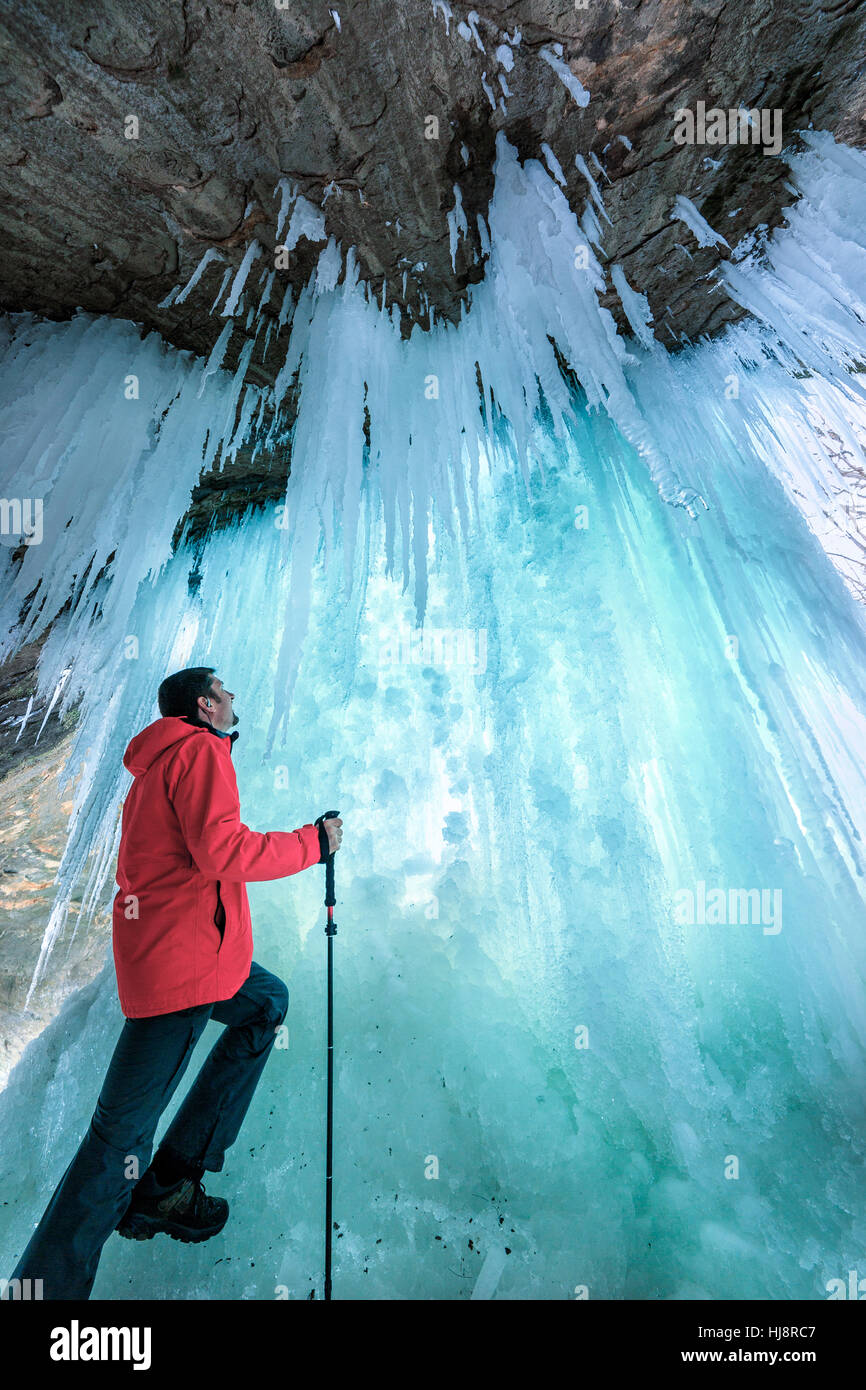 Man standing behind a frozen waterfall, Matthiessen State Park ...