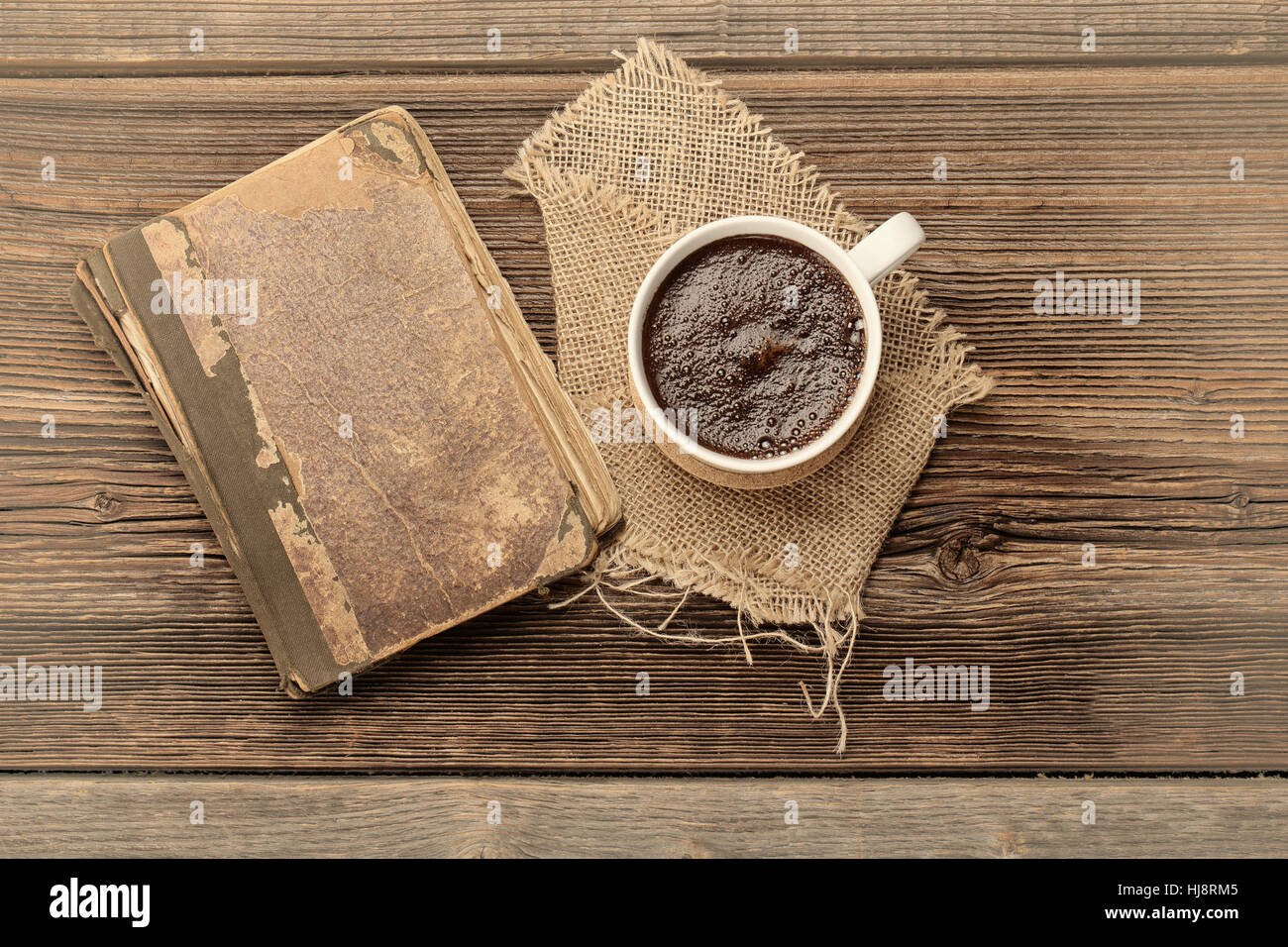 Old book and cup of coffee on vintage wooden background with empty ...