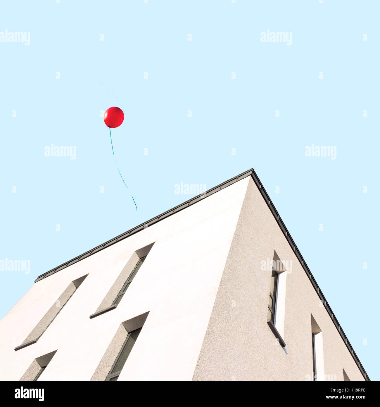 Balloon flying above a building Stock Photo - Alamy