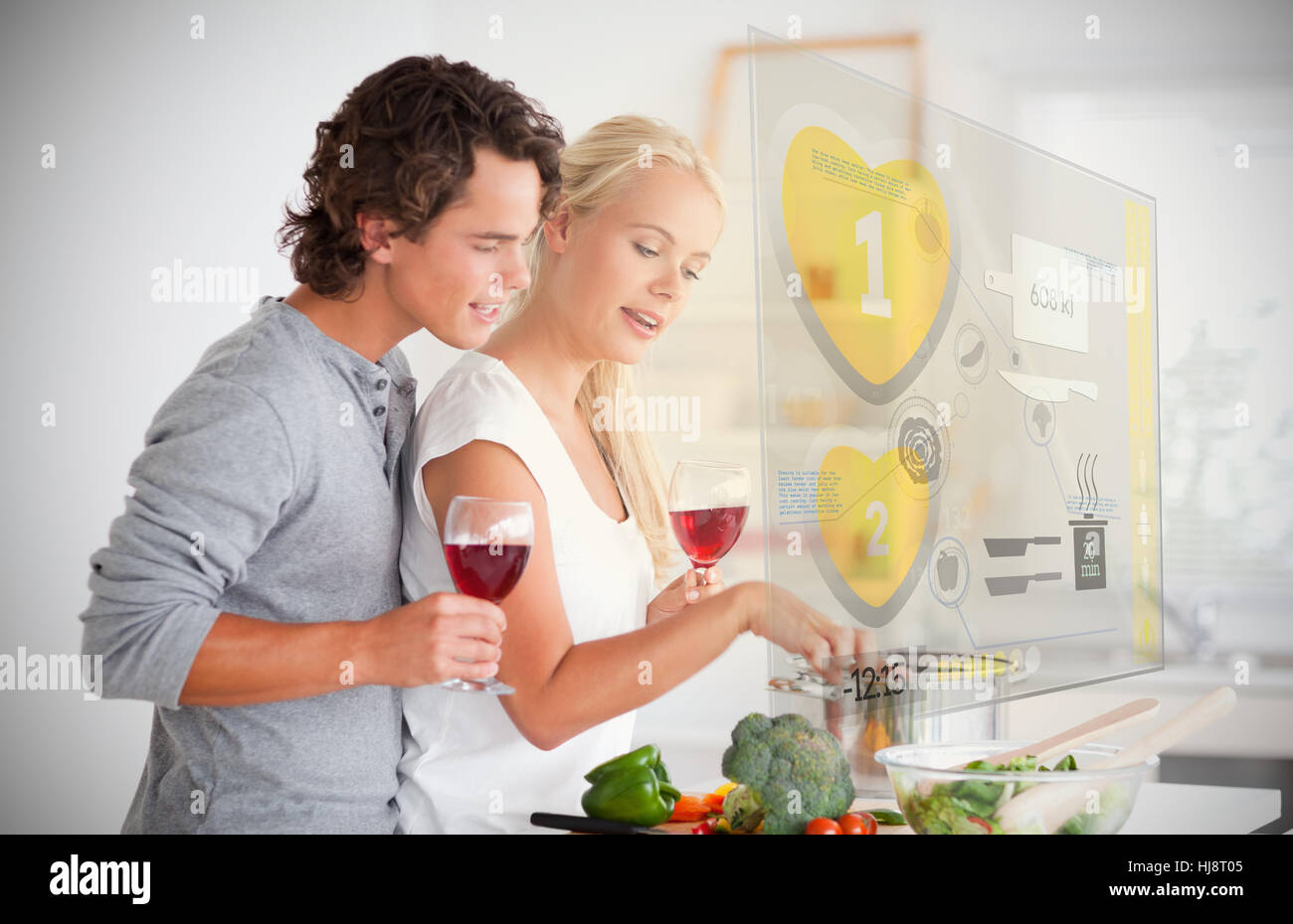 Couple making dinner using interface instructions in the kitchen Stock ...