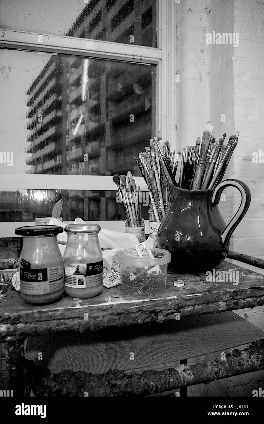Artist studio window with brushes in a jug Stock Photo - Alamy