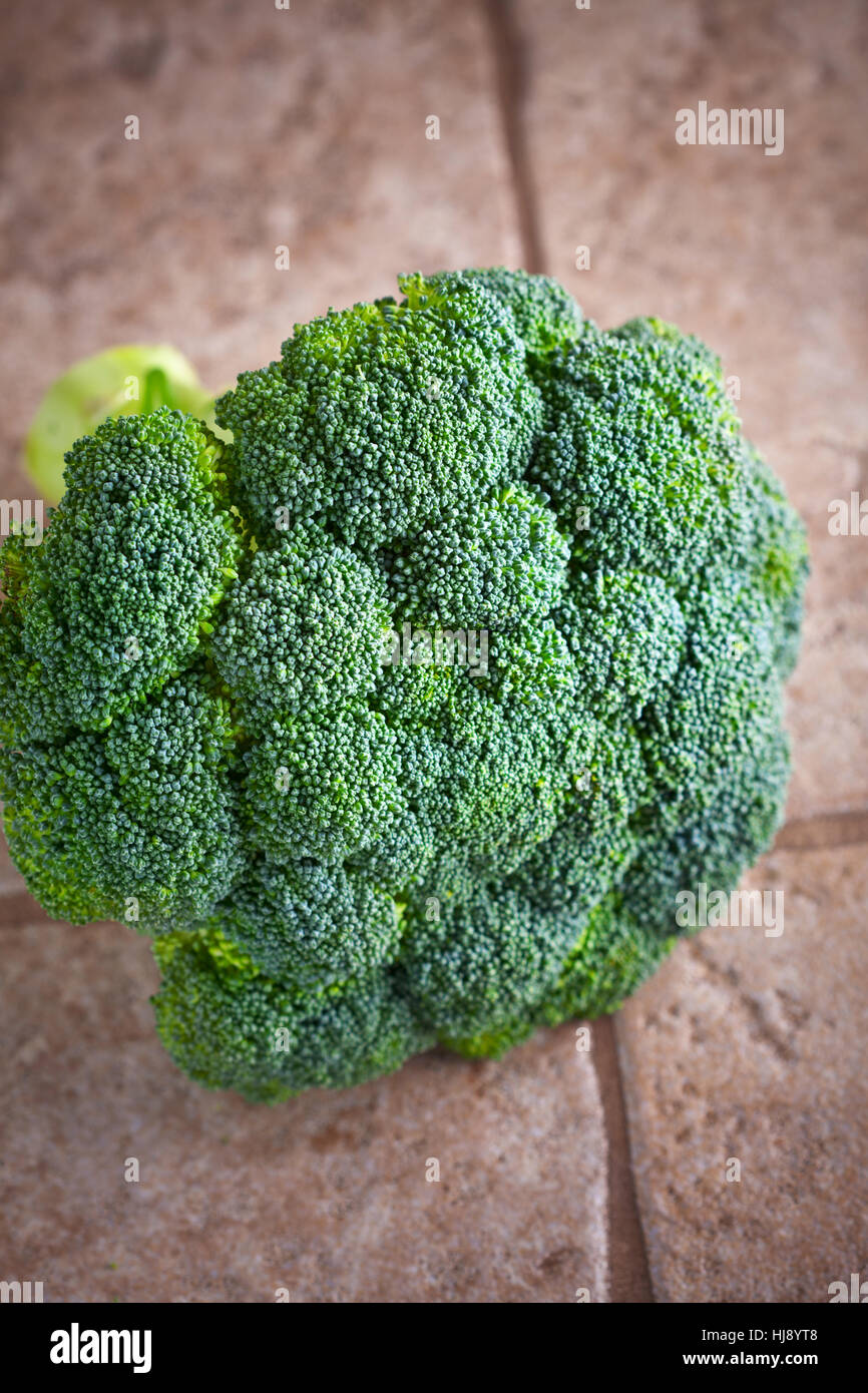 Green fresh head of Broccoli on a stone surface Stock Photo - Alamy