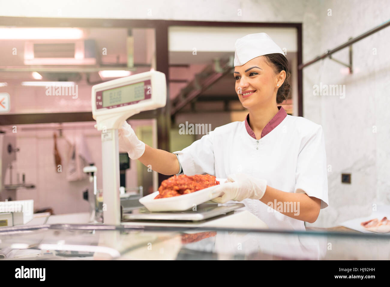 Pretty Butchery Woman working in butchery shop Stock Photo - Alamy