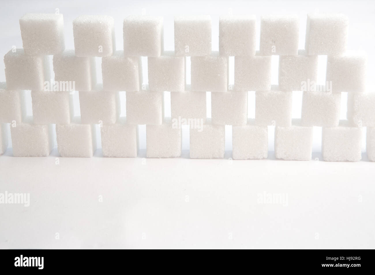Sugar lumps piled up together against a white background Stock Photo ...
