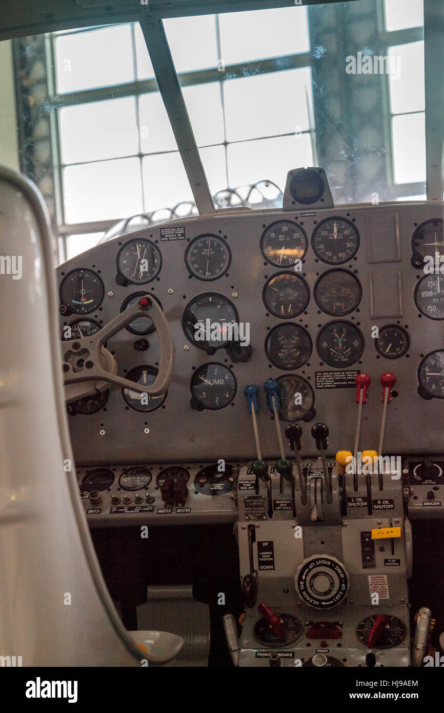 Airplane cockpit control panel with various buttons, levers, displays ...