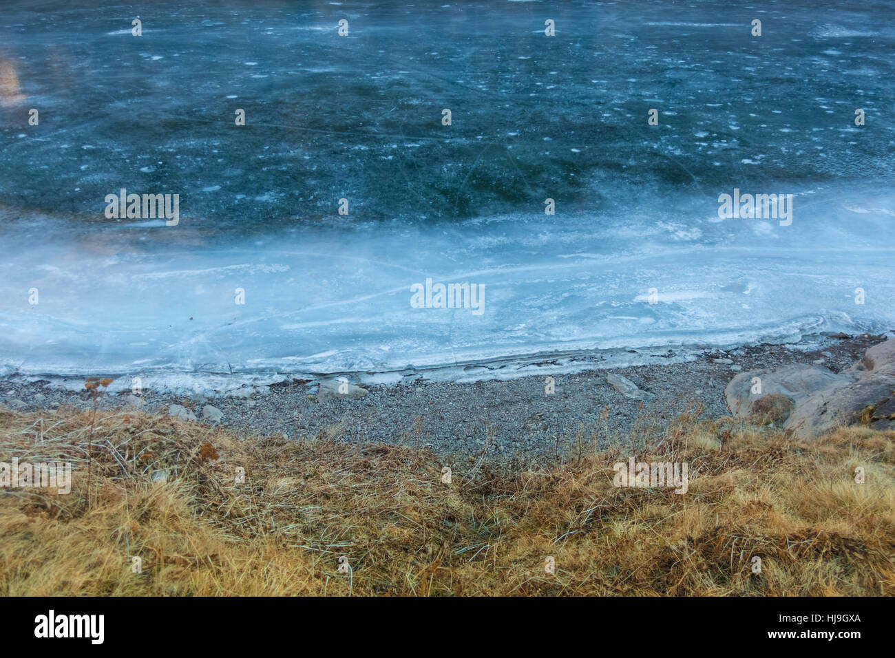Iced lake and rocky beach Stock Photo - Alamy