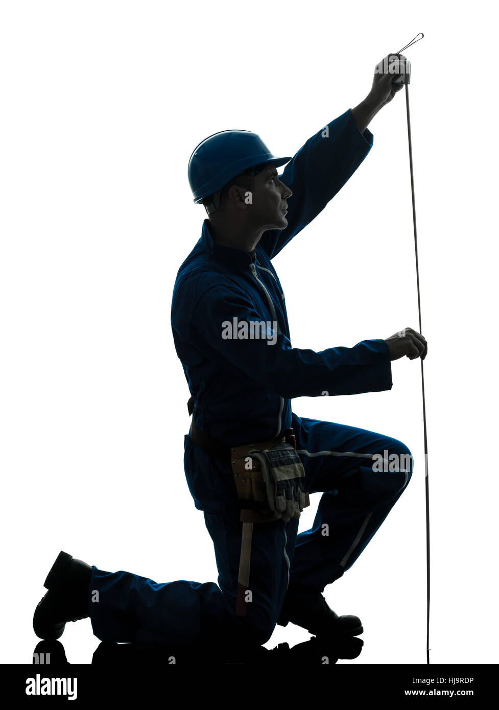one caucasian man construction worker Tape Measure silhouette in studio ...
