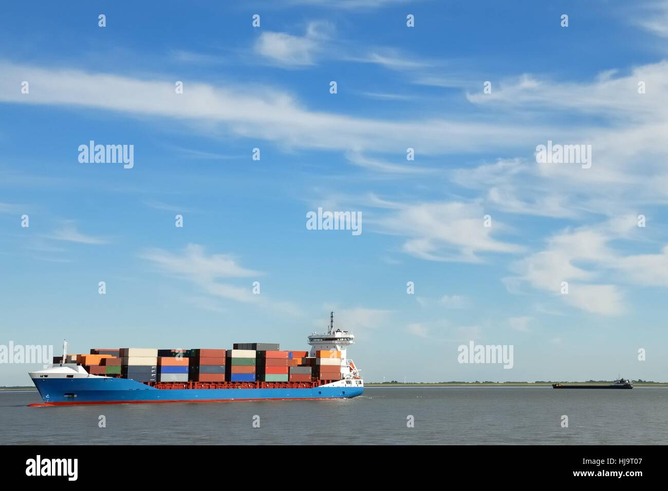 feeder ship under blue sky Stock Photo - Alamy