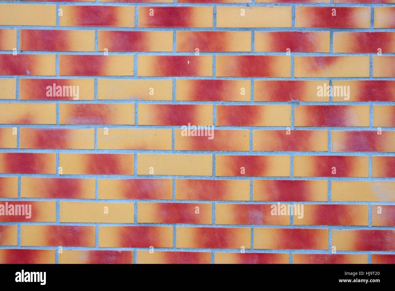 Brick wall with red-yellow gradient color bricks Stock Photo - Alamy