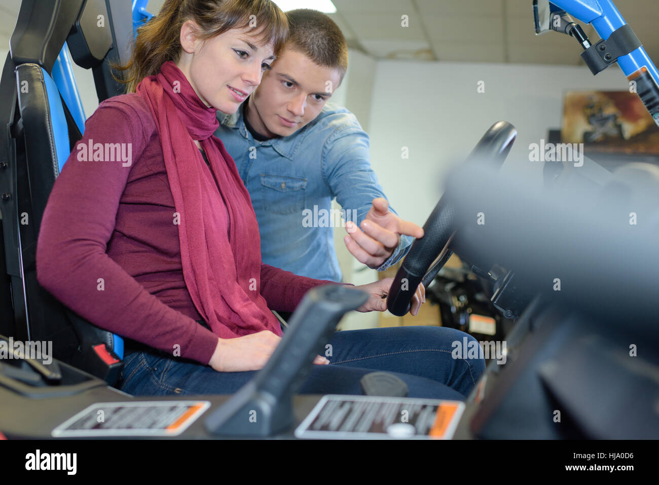 Salesman explaining controls of buggy to woman Stock Photo - Alamy