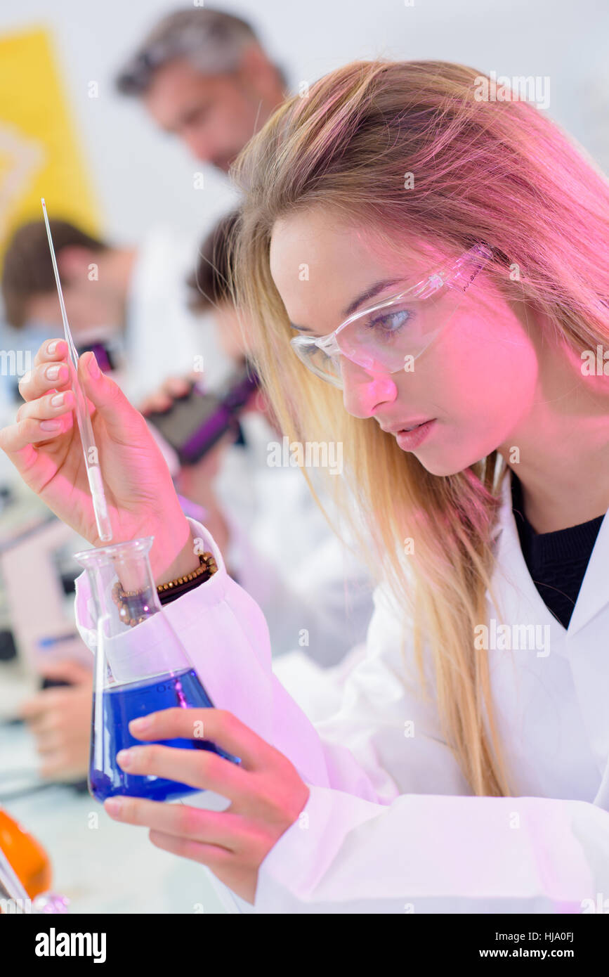 Young scientist holding glass flask Stock Photo - Alamy