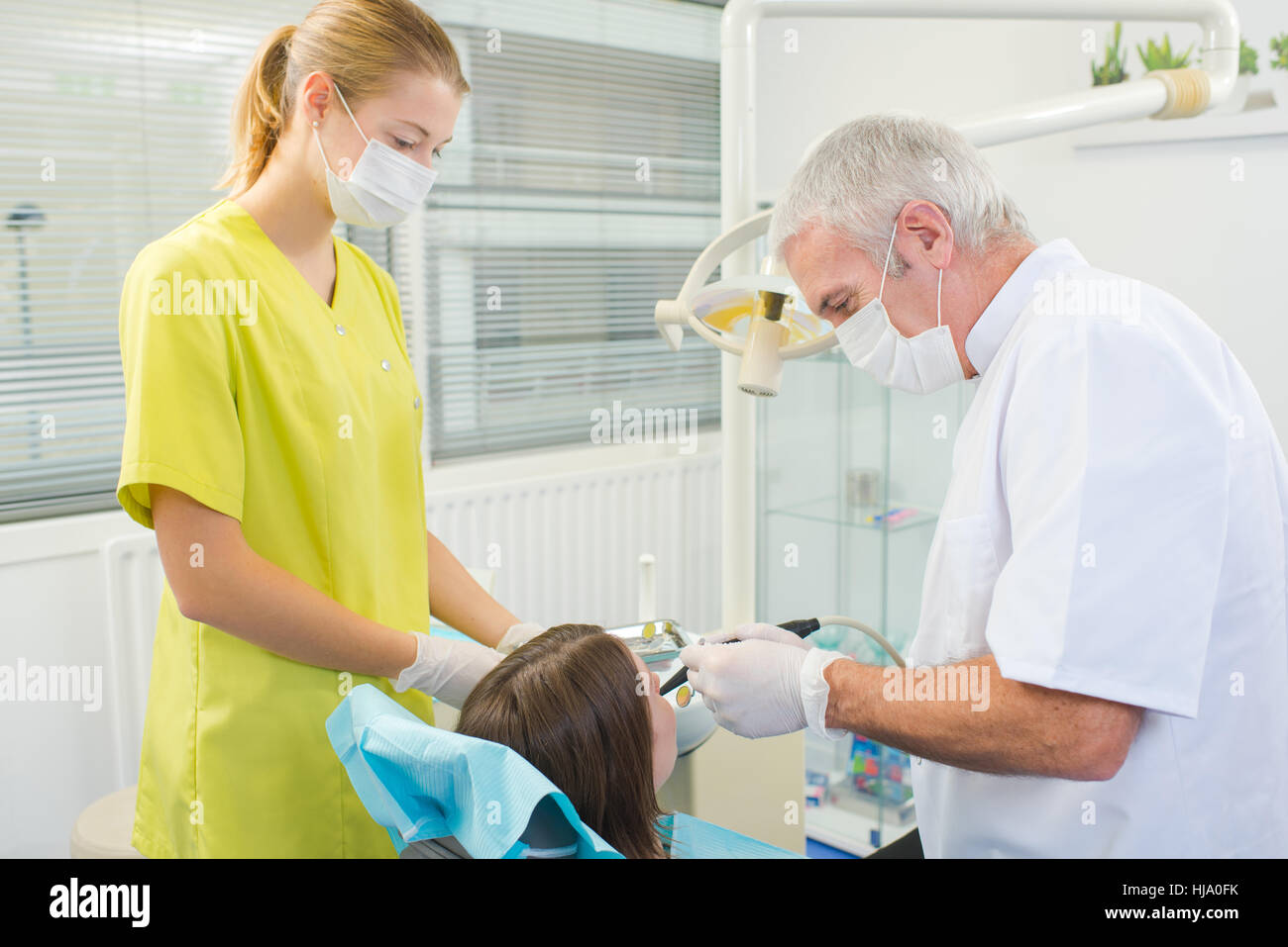 Busy dentist with a patient Stock Photo - Alamy