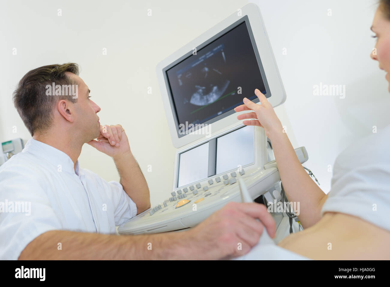 pregnant woman getting ultrasound from doctor in clinic Stock Photo - Alamy