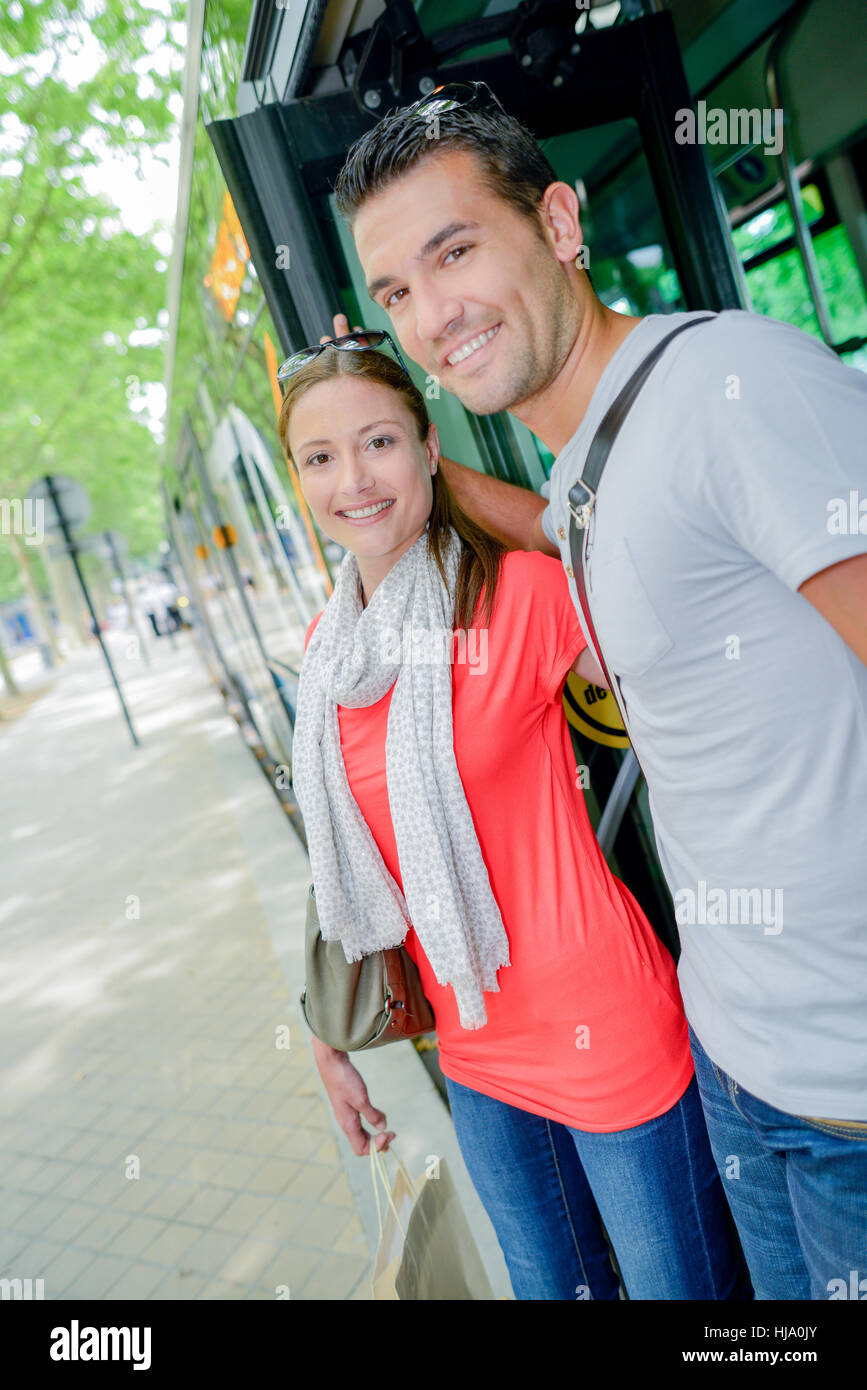 Couple getting off a bus Stock Photo - Alamy
