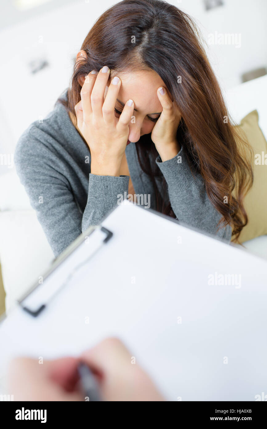 Woman crying in therapy Stock Photo - Alamy