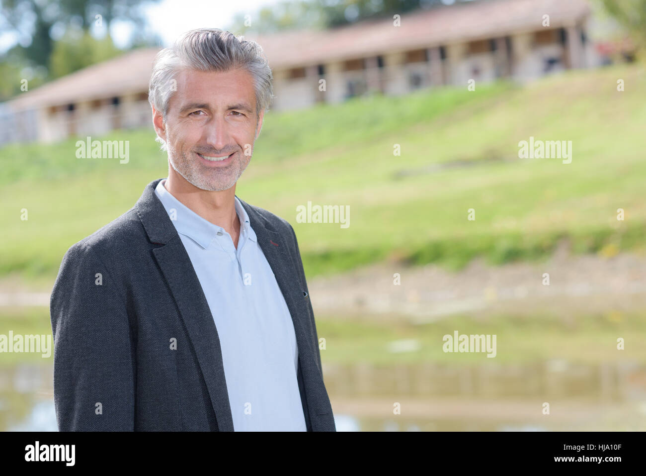 Portrait of man at riding stables Stock Photo - Alamy