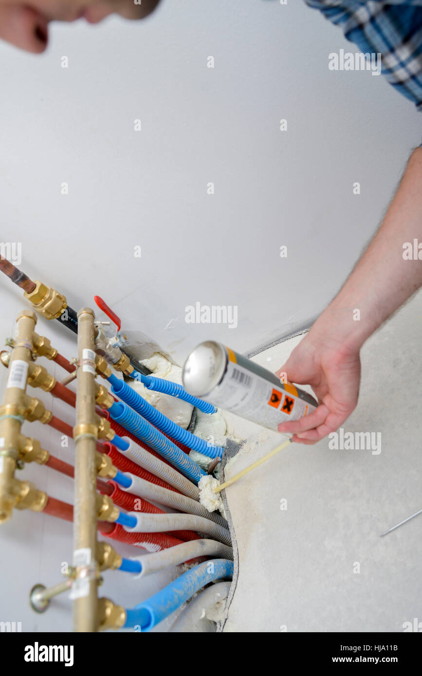 Plumber checking all the pipes Stock Photo - Alamy