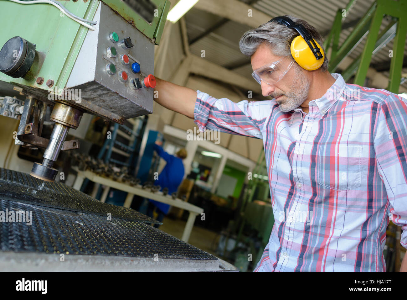 machine tender in the factory Stock Photo - Alamy