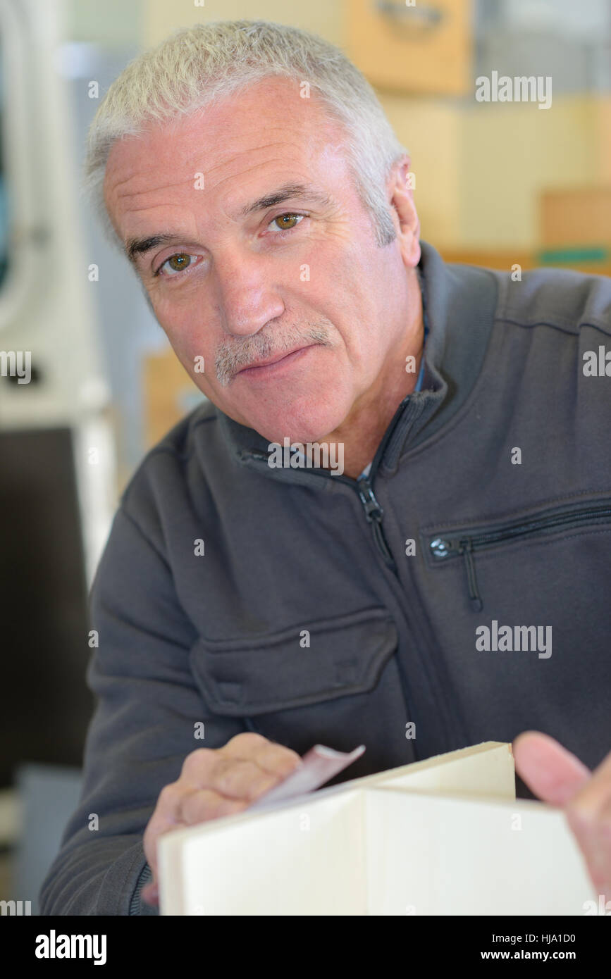 Portrait of man using sandpaper Stock Photo - Alamy