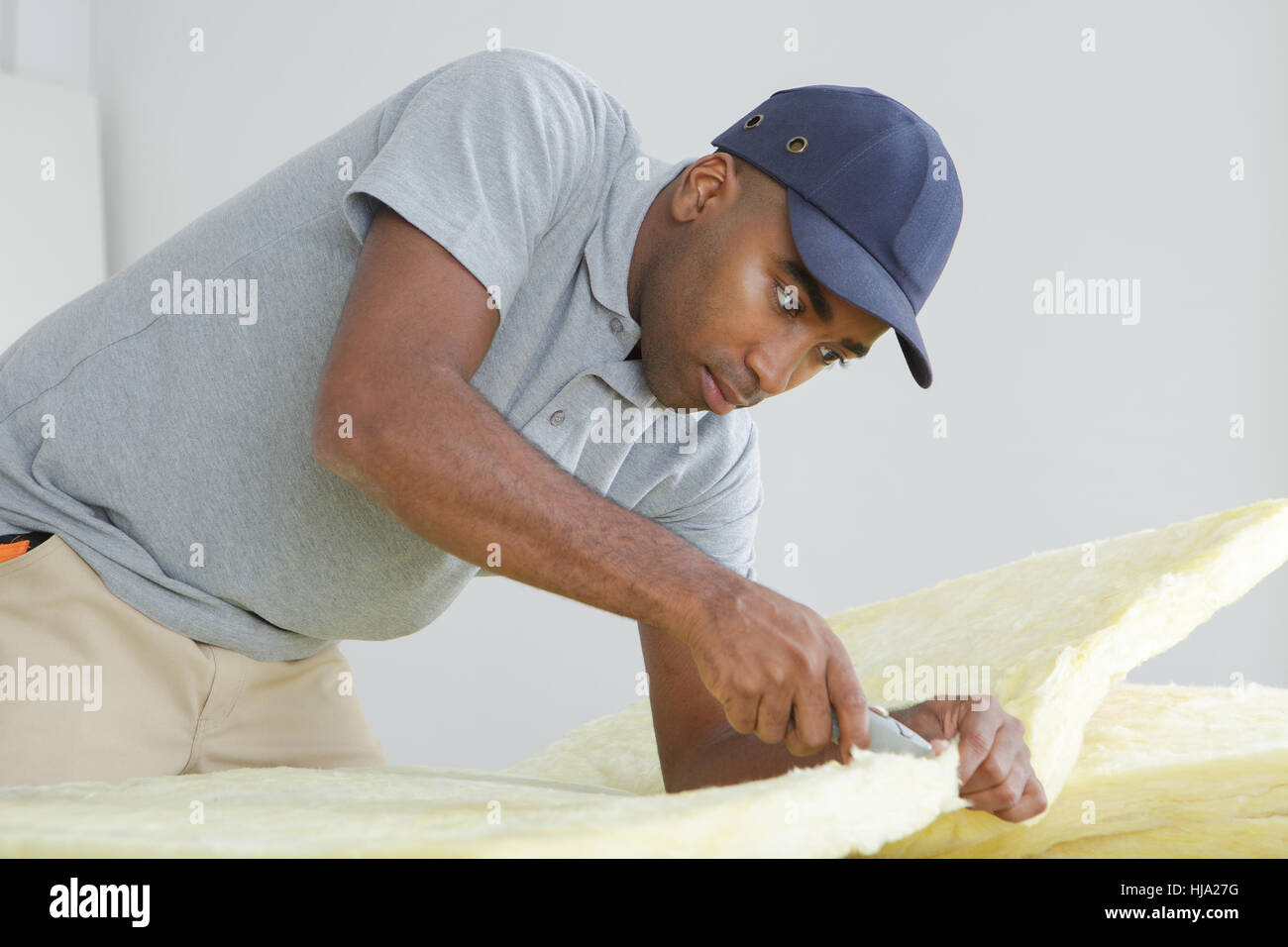 Man cutting through insulation Stock Photo - Alamy