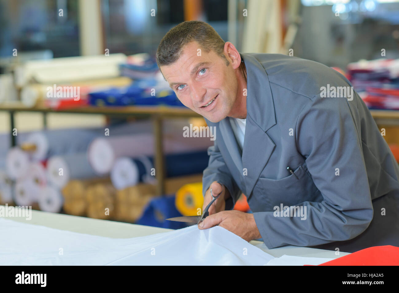 Man cutting material Stock Photo - Alamy