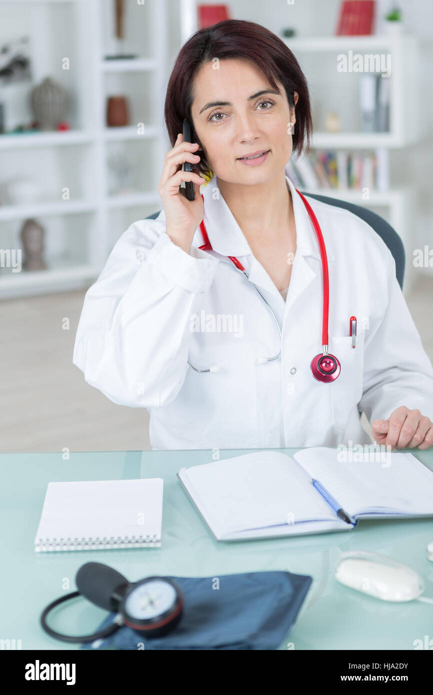 female doctor talking on phone in her office Stock Photo - Alamy