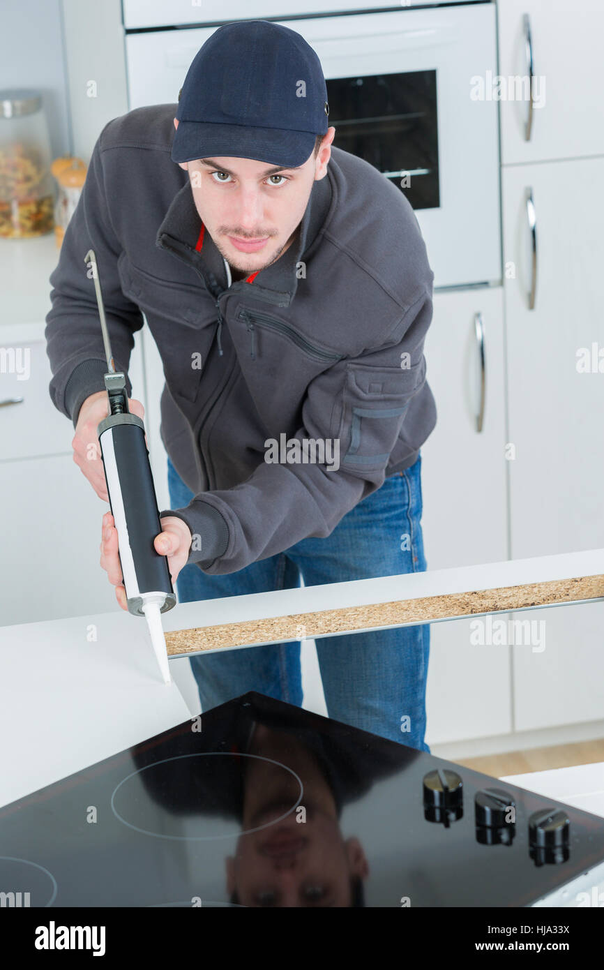 worker holding an industrial glue Stock Photo - Alamy