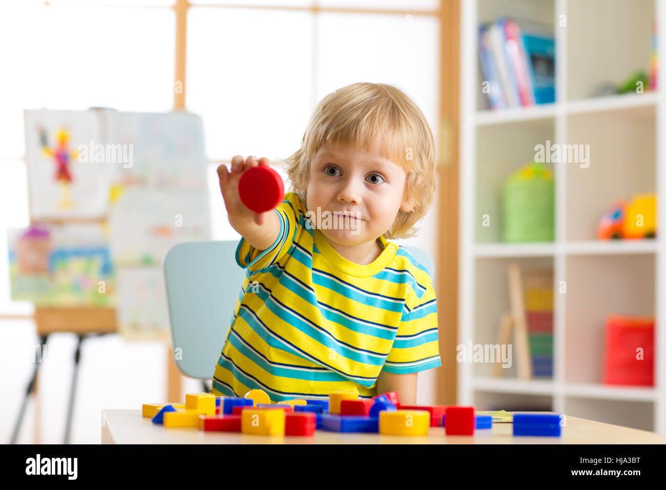 Child little boy learning shapes, early education and daycare concept ...