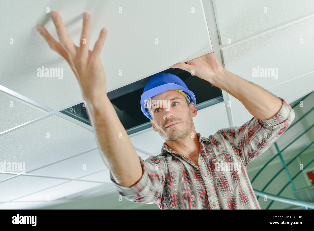 Manual worker inspecting ceiling Stock Photo - Alamy