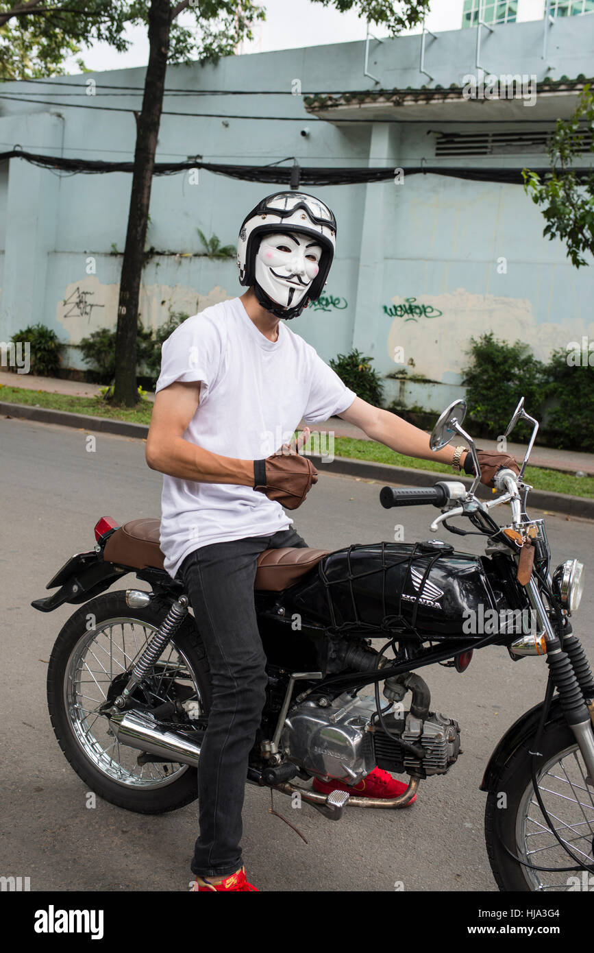 Man with an Extinction Rebellion mask on a motorbike, Saigon Stock ...